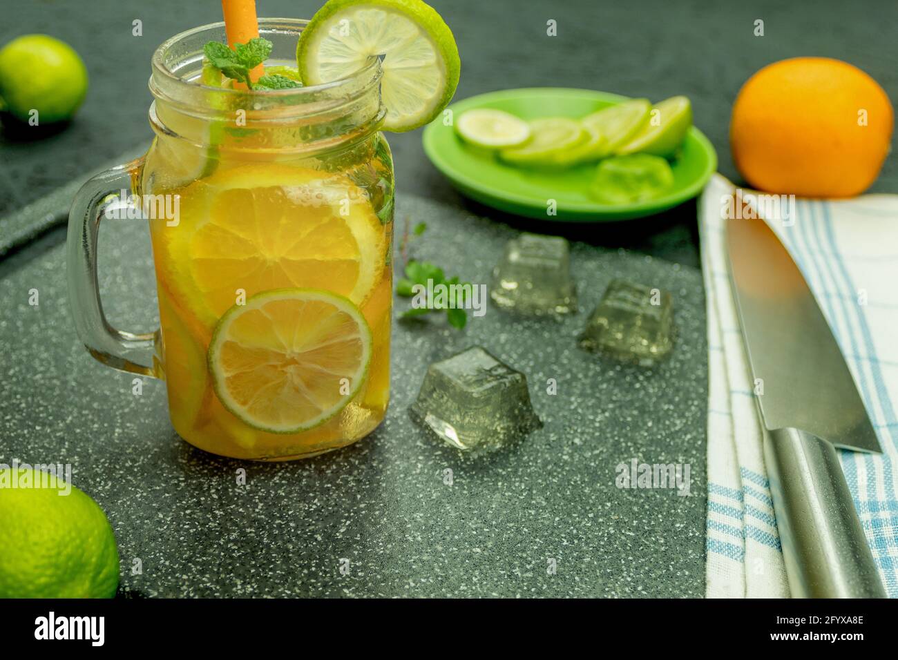 Cool lemonade made from orange and ice cubes. Water drops. Refreshing ...