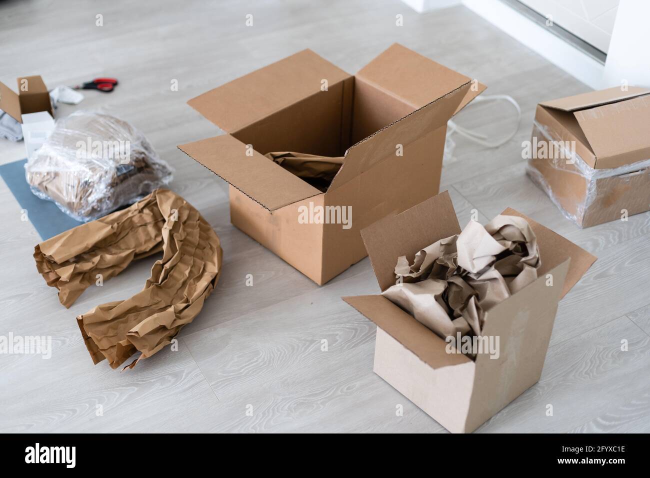 open Parcel box on floor near open door Stock Photo - Alamy