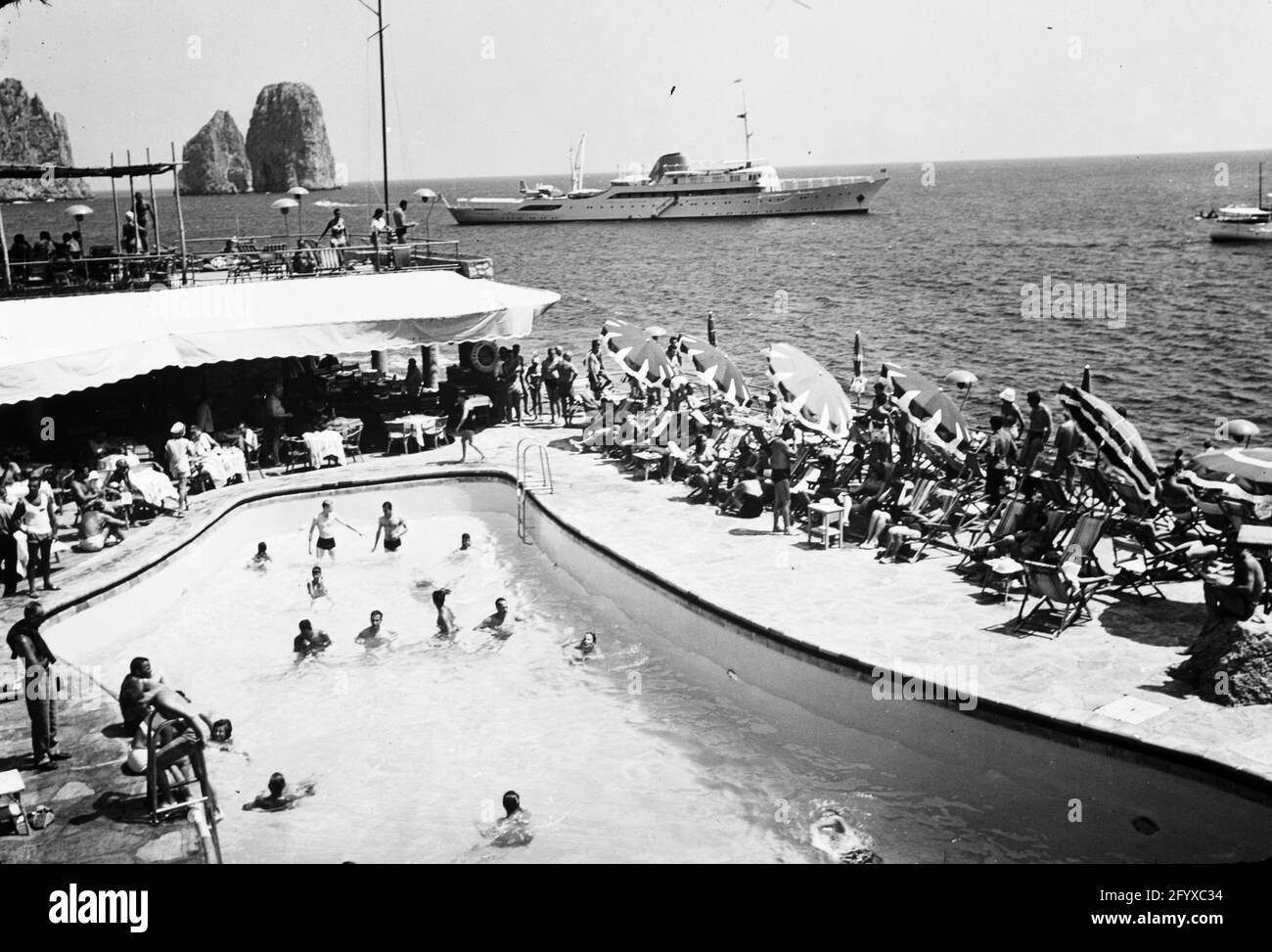 Resort Swimming pool with Yacht in Background, ca 1930 Stock Photo - Alamy