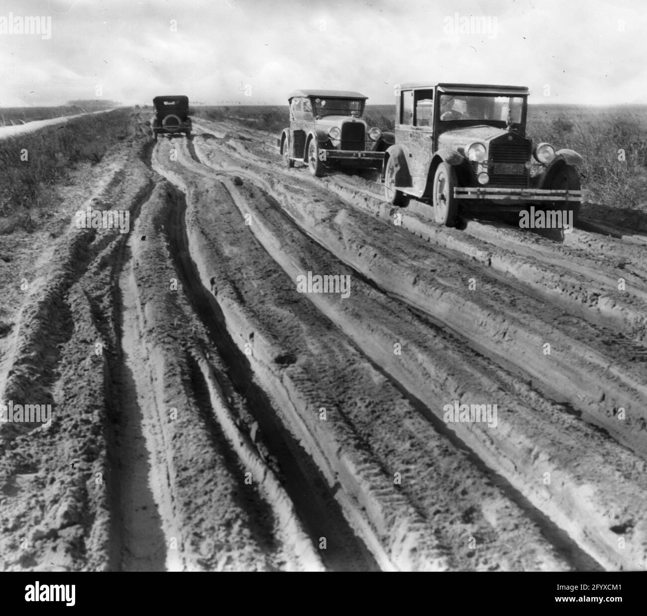 Cars on a heavily rutted dirt road, Southern United States of America ...