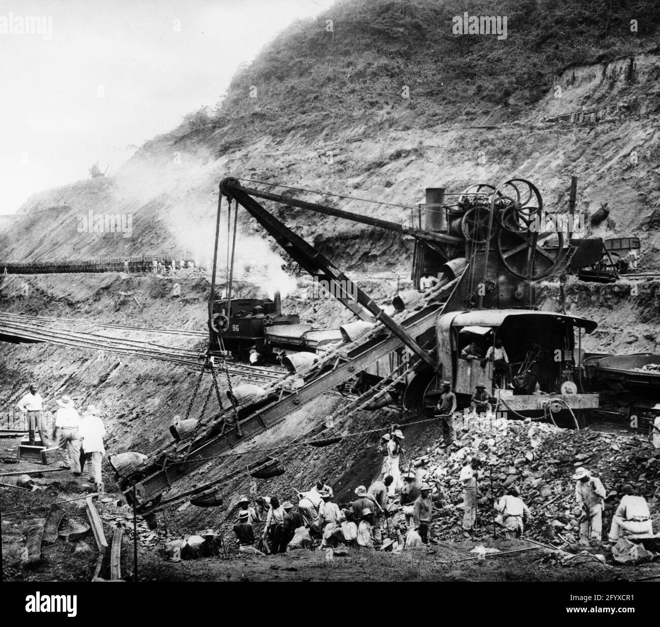 Construction workers near an earth mover during the construction of the ...