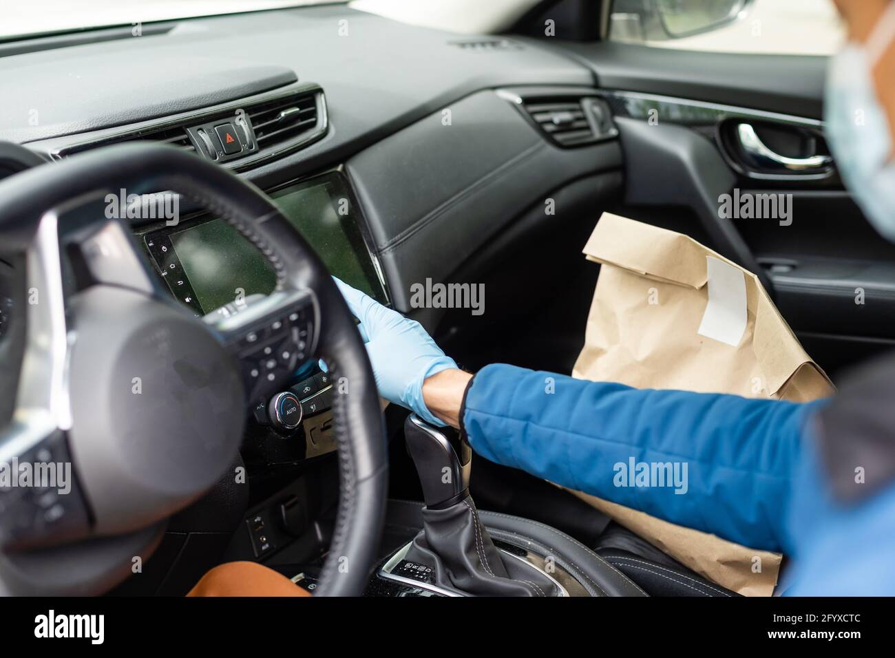 Delivery driver driving with parcels on seat Stock Photo - Alamy