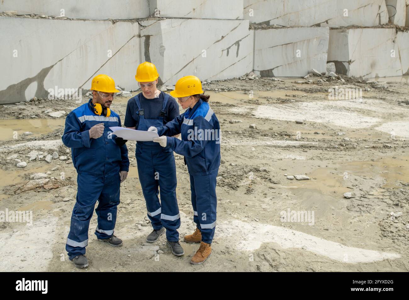 One of modern builders pointing at sketch of construction during ...