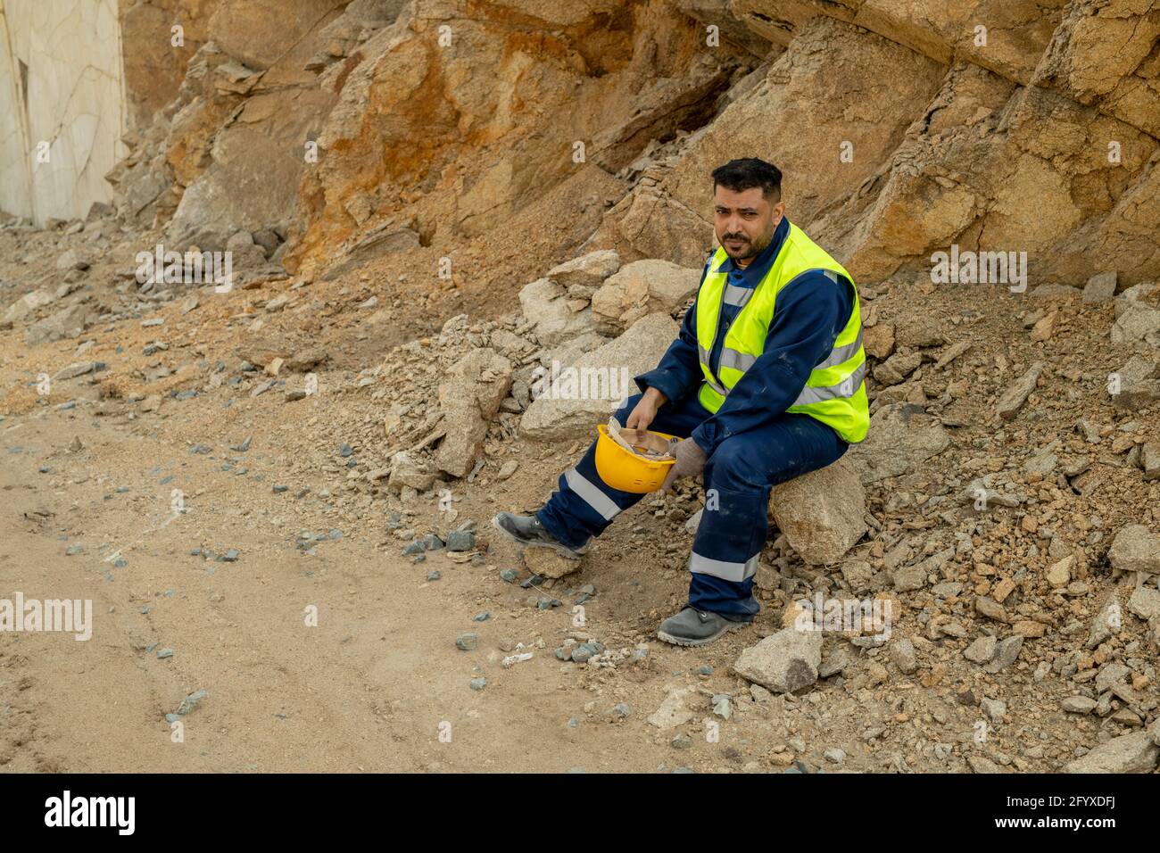Restful builder in uniform having break at construction site Stock ...