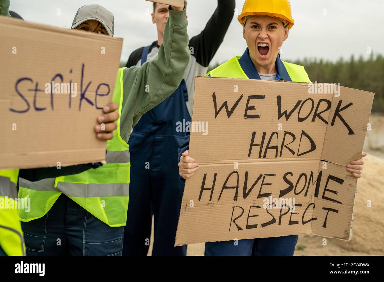 Crowd of dissatisfied builders standing for their rights on strike ...