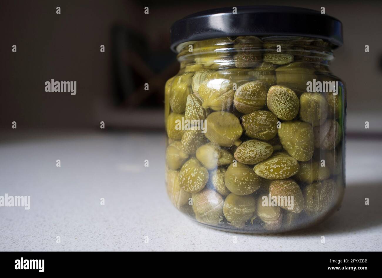 Glass jar of spanish pickle capers. Closeup Stock Photo - Alamy