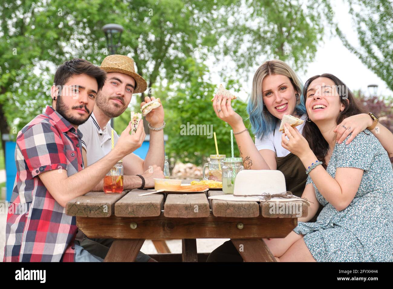 Group happy friends eating sandwiches hi-res stock photography and ...