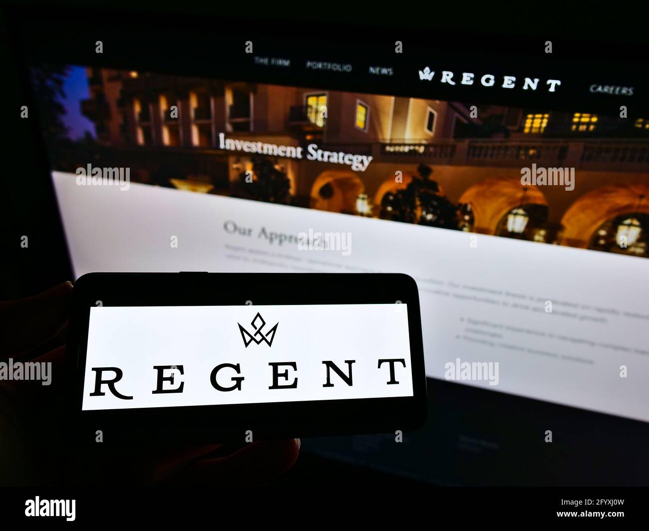 Person holding mobile phone with business logo of American private ...