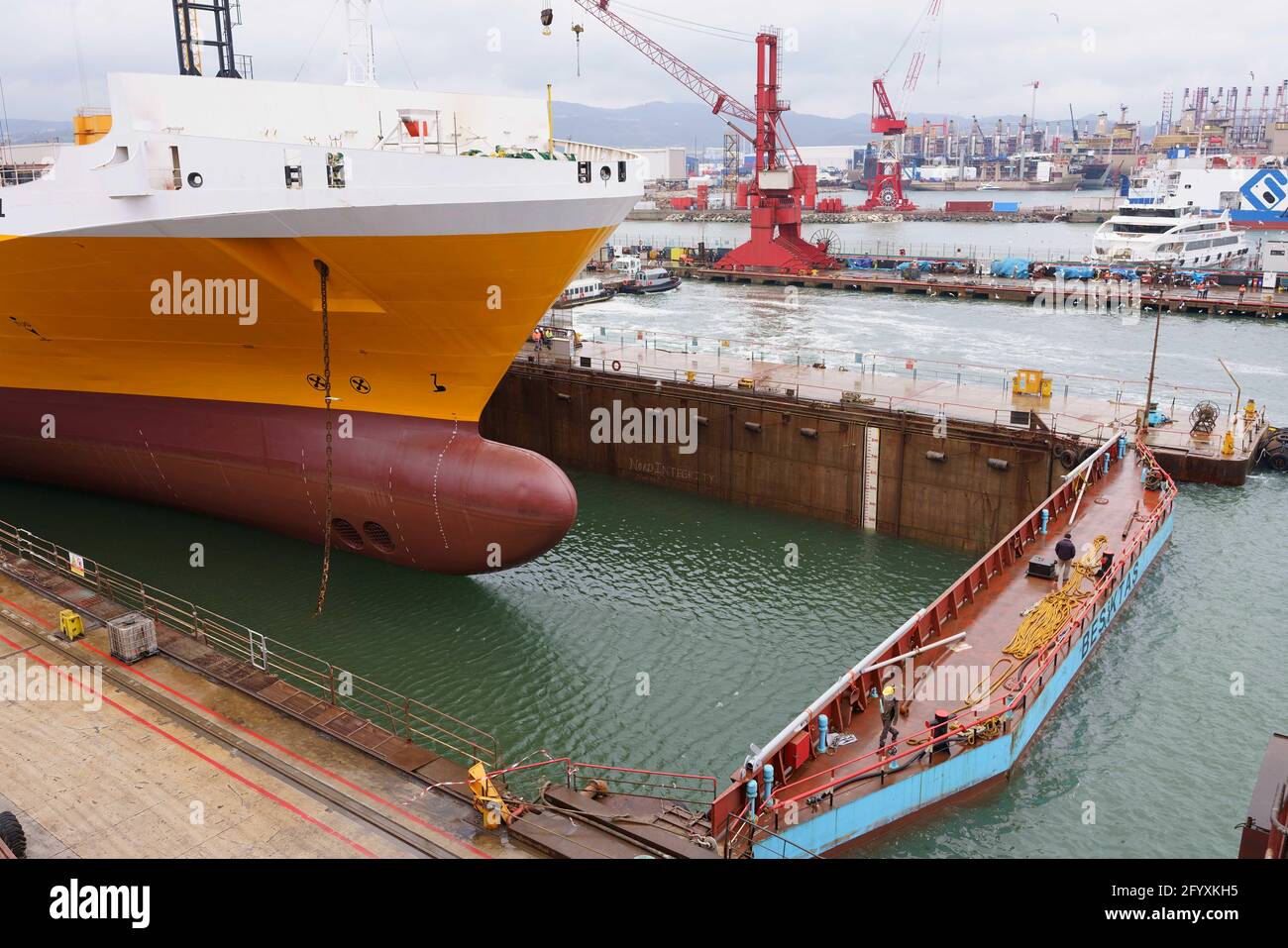 orange side paint cargo vessel in dock Stock Photo - Alamy