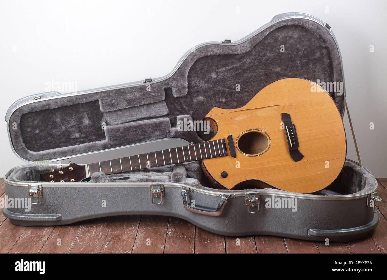 Musical instrument - Broken acoustic guitar in hard case on a white ...