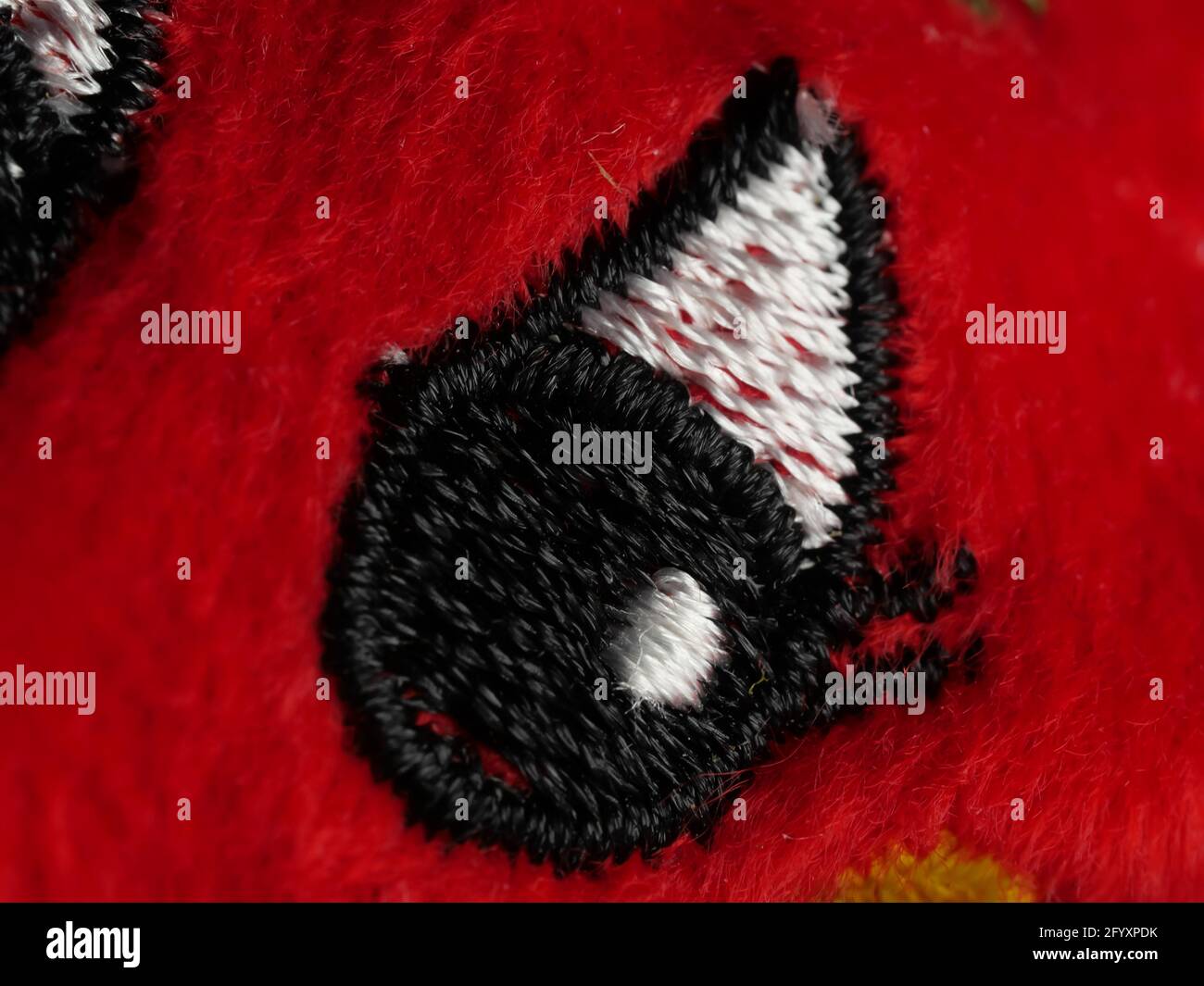 A closeup of red cloth with a knitted eye Stock Photo - Alamy