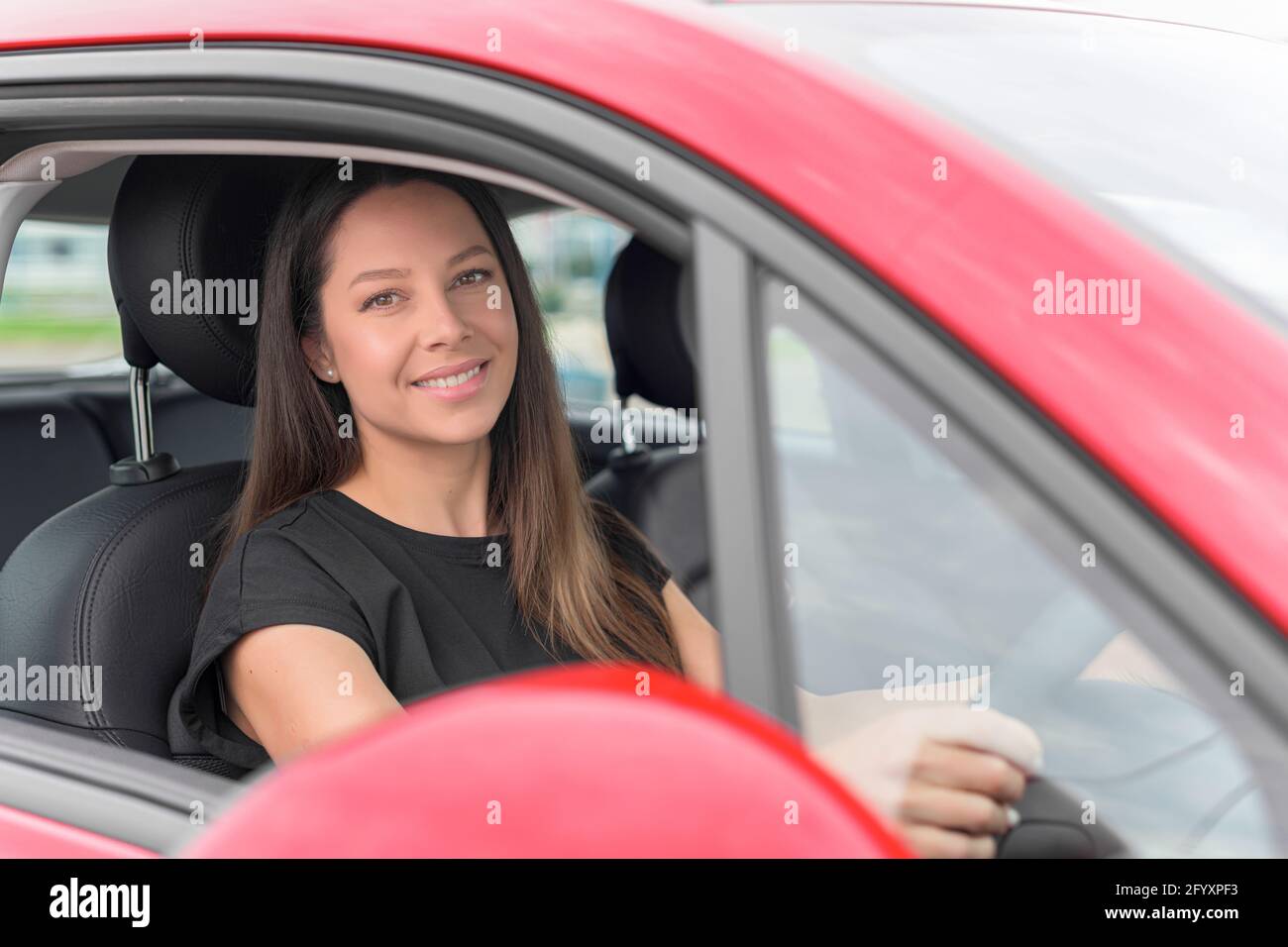 Beautiful young woman driving a car Stock Photo - Alamy