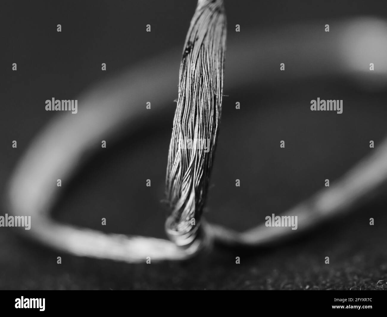 A dramatic grayscale of metal cable wire details on blurred background ...