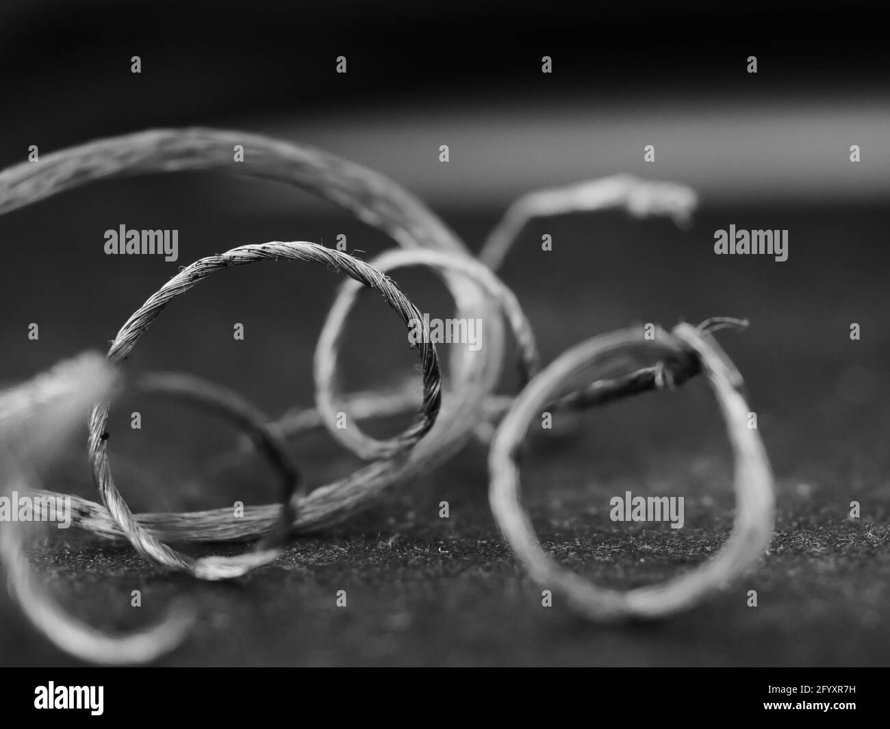 A dramatic grayscale of metal cable wire details on blurred background ...