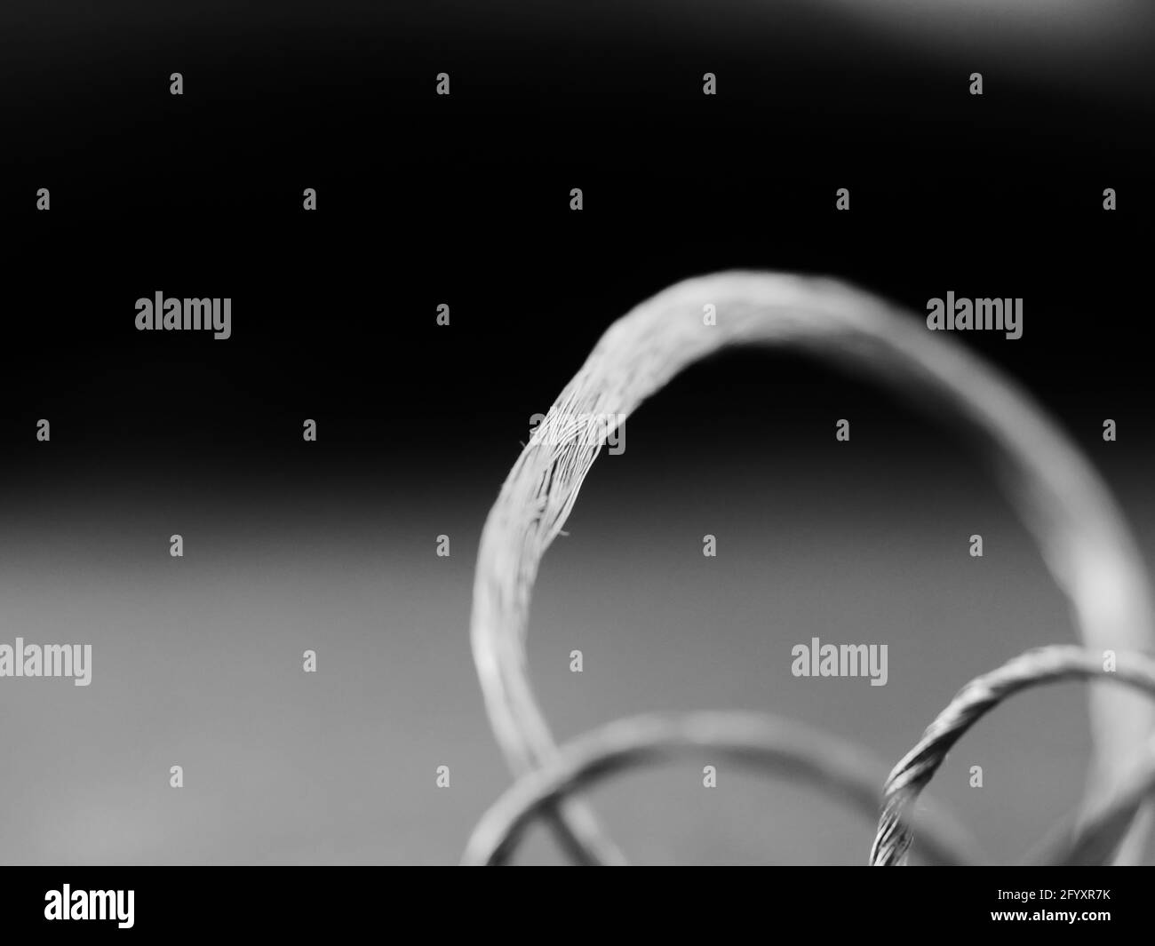 A dramatic grayscale of metal cable wire details on blurred background ...