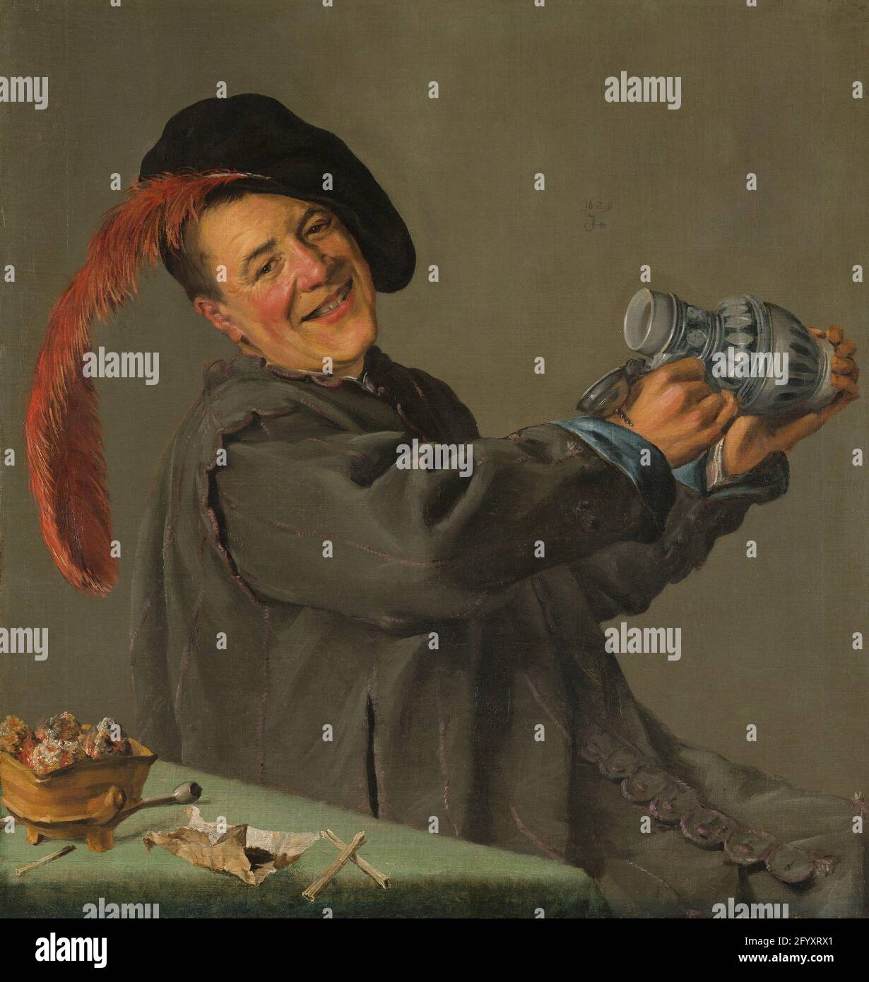 The Jolly Drinker. The cheerful drinker. A smiling man holds a jug with ...