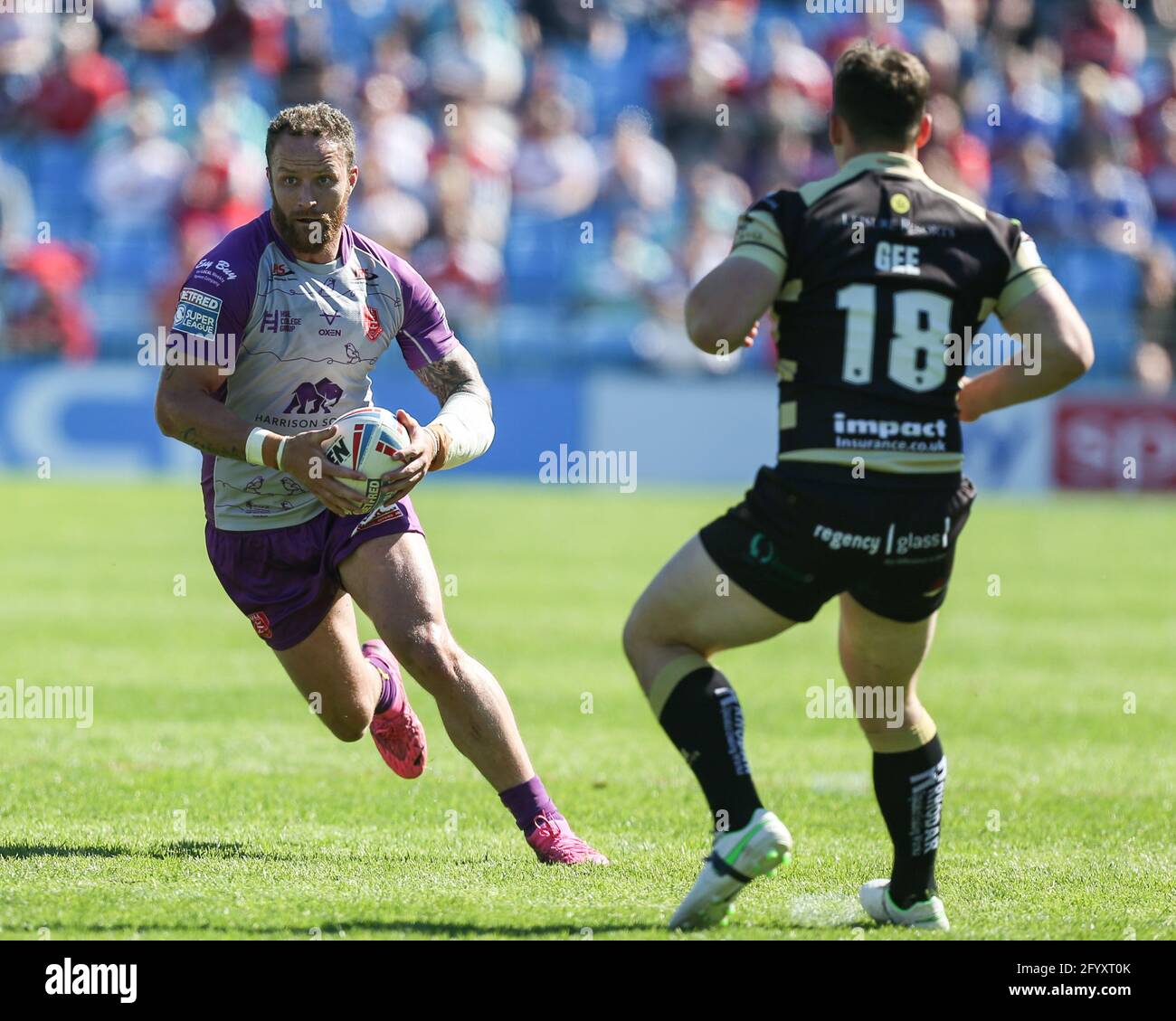 Korbin Sims (10) of Hull KR looks to go past Matty Gee (18) of Leigh ...