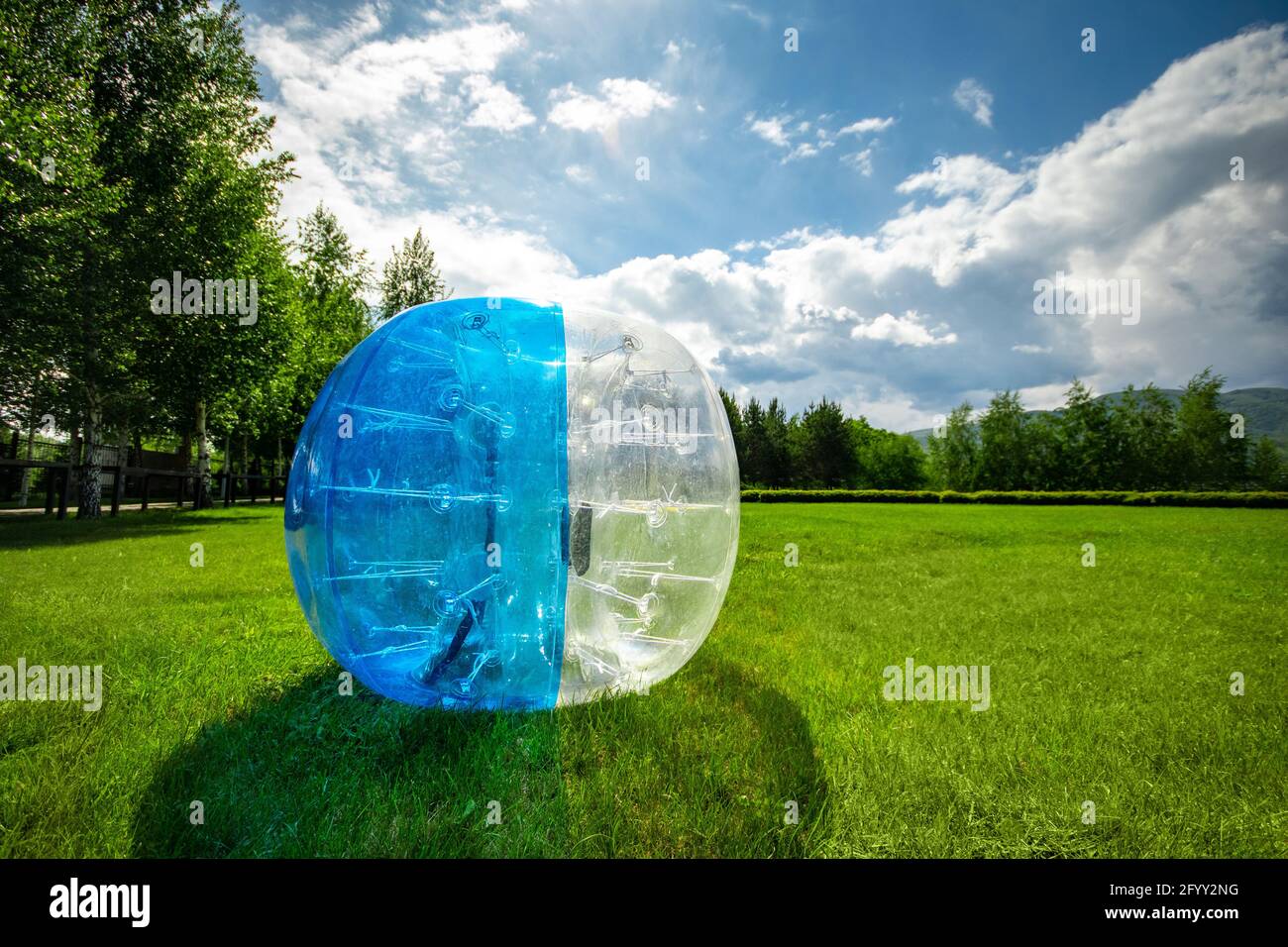 Zorbing Balloon on the summer lawn. inflatable zorb ball outdoor ...