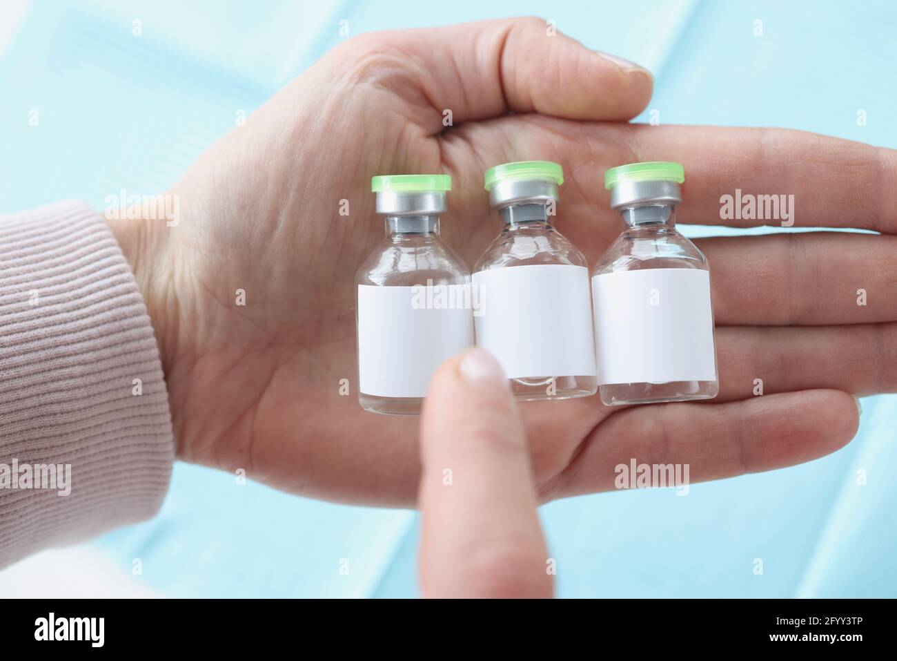 Holding three vials of coronavirus vaccine of choice in hand Stock ...