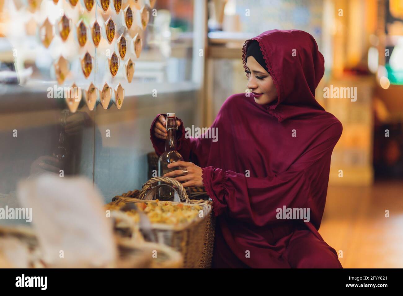 Arabian young muslim woman sitting in a cafe Stock Photo - Alamy