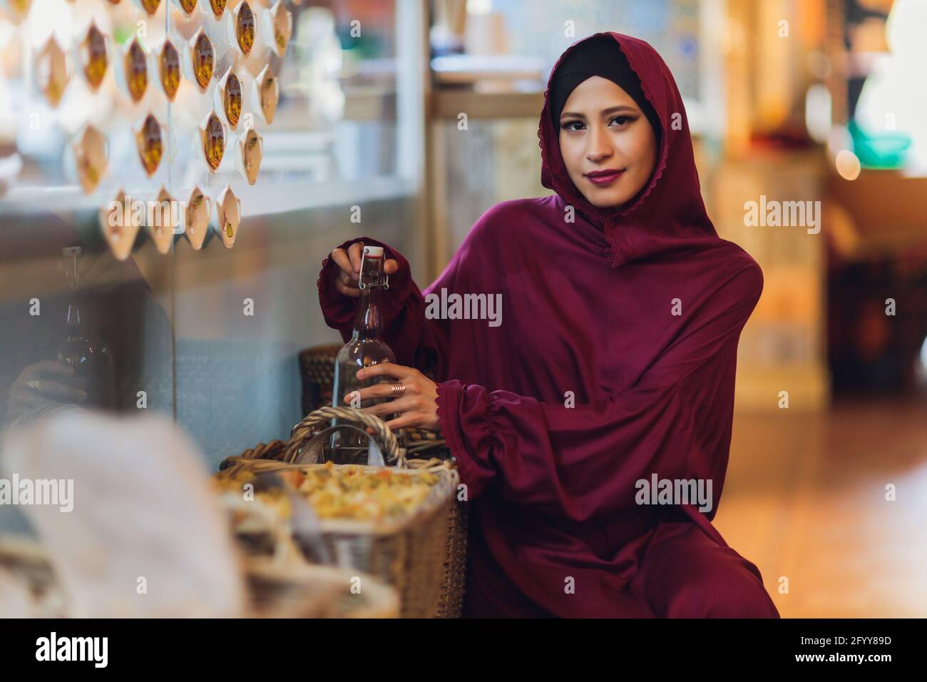 Arabian young muslim woman sitting in a cafe Stock Photo - Alamy