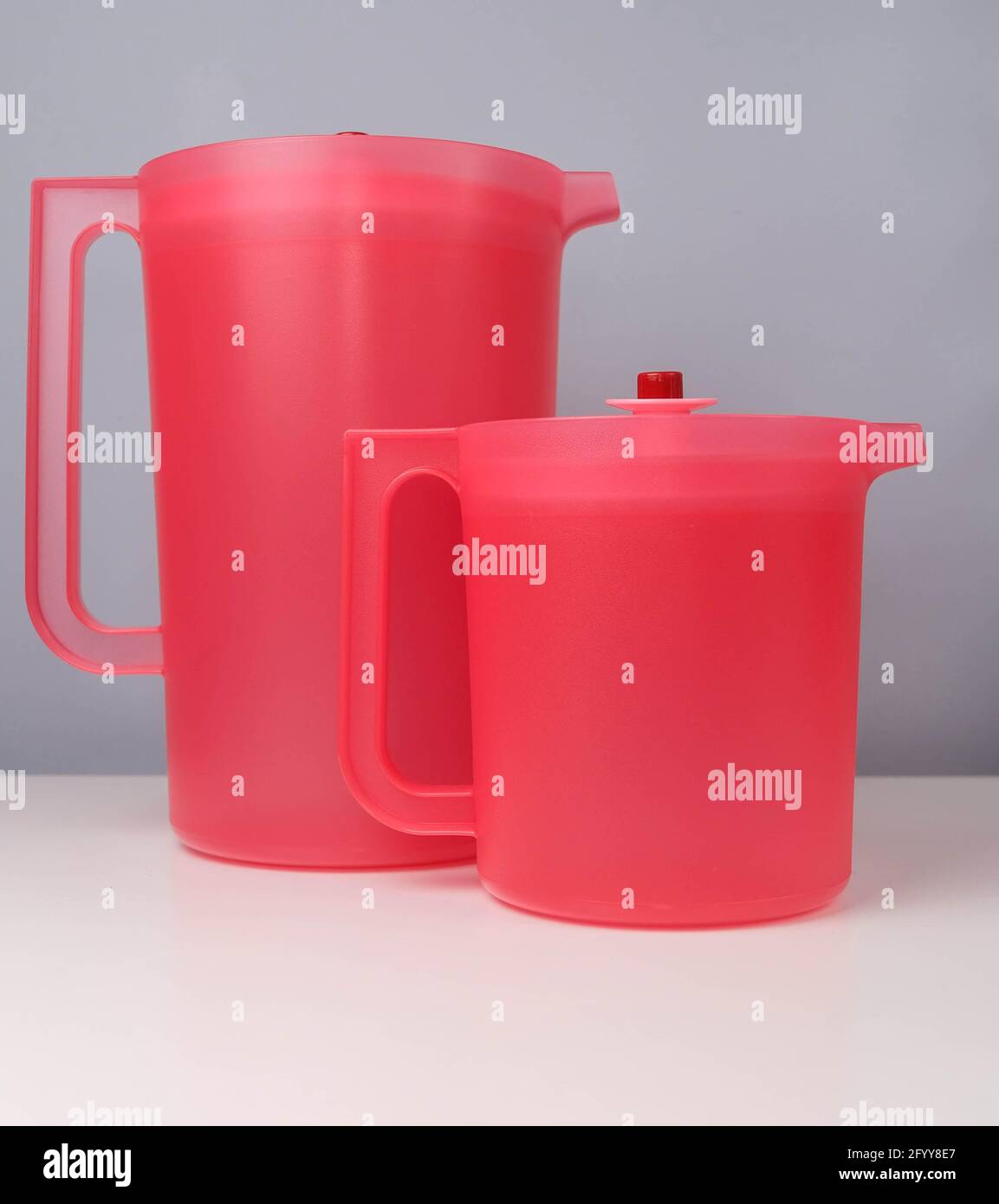 Red water jug isolated on a grey and white background Stock Photo - Alamy