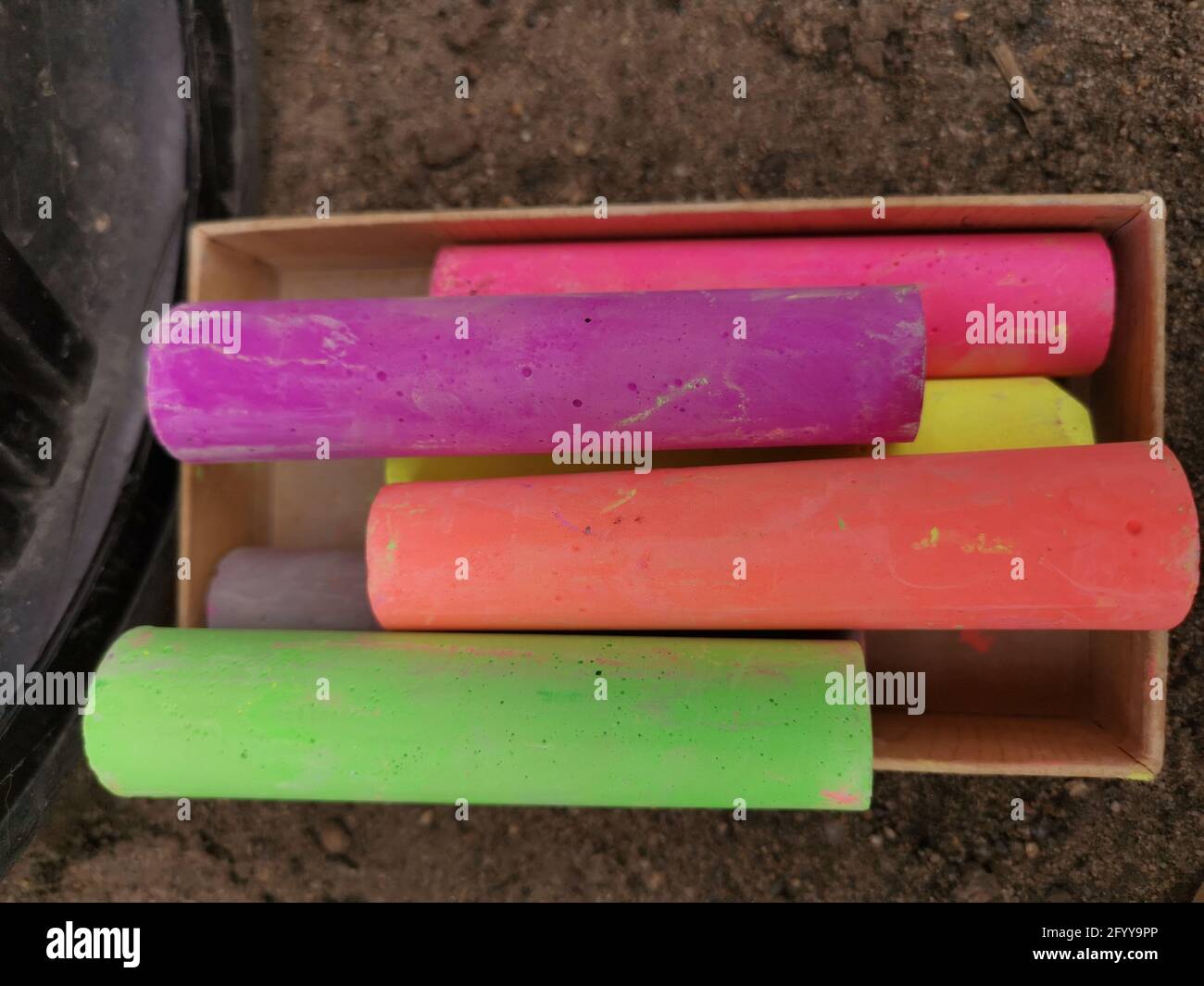 A top view of round colorful chalks in a small box Stock Photo - Alamy