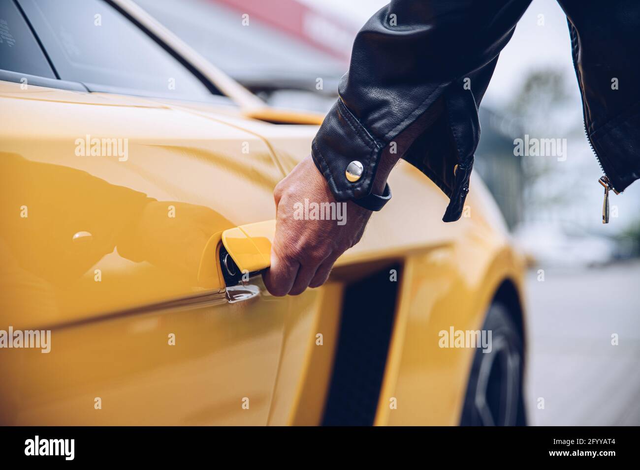 Man is reaching for the car door handle Stock Photo - Alamy