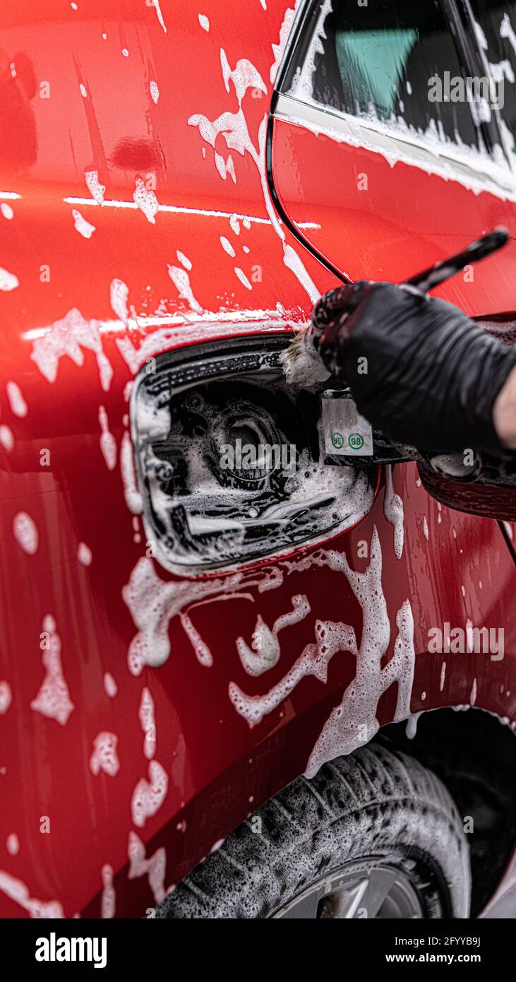 Man worker cleans and washes the fuel filler Stock Photo - Alamy
