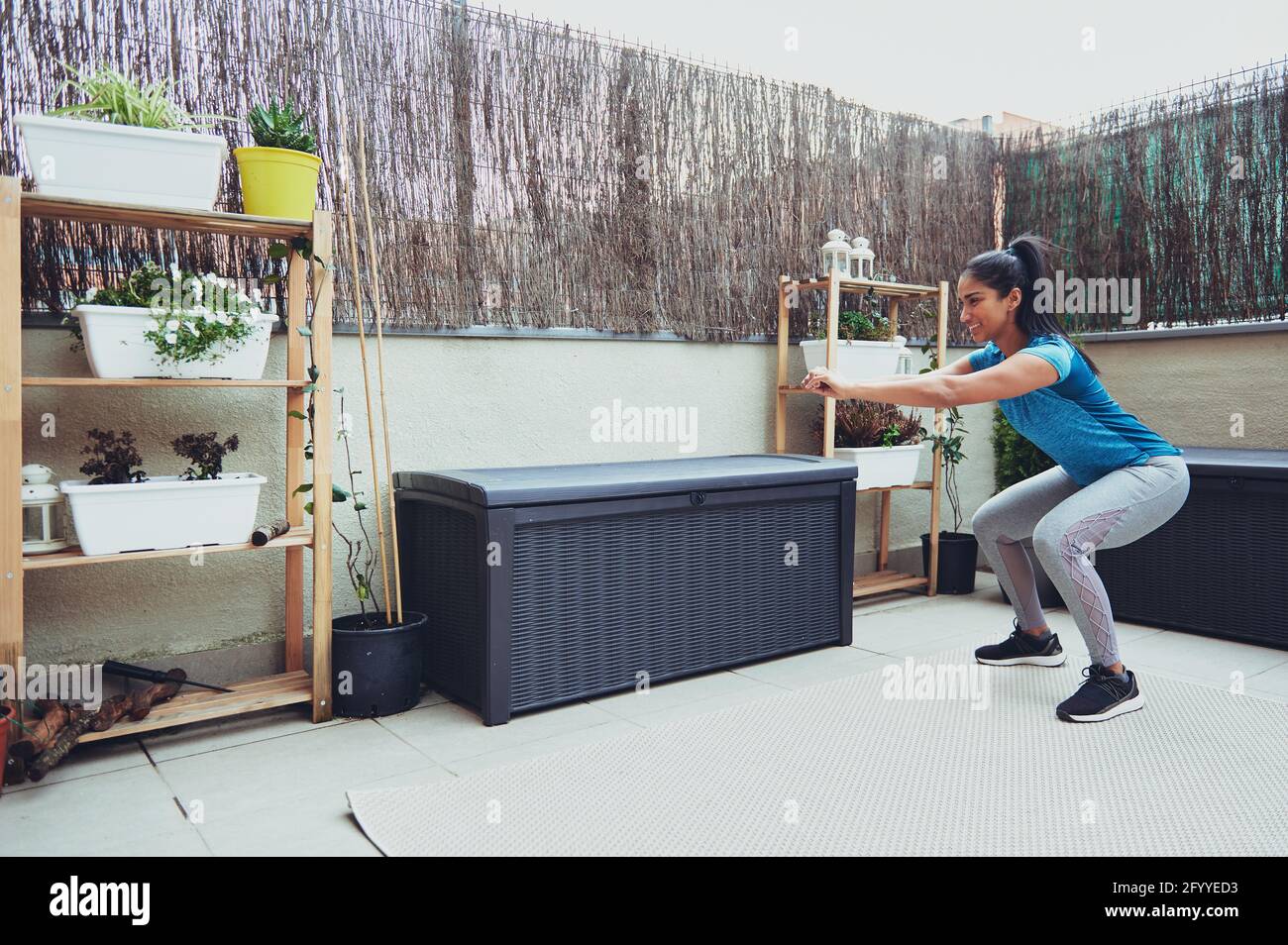 Side view of content ethnic female athlete in activewear working out ...