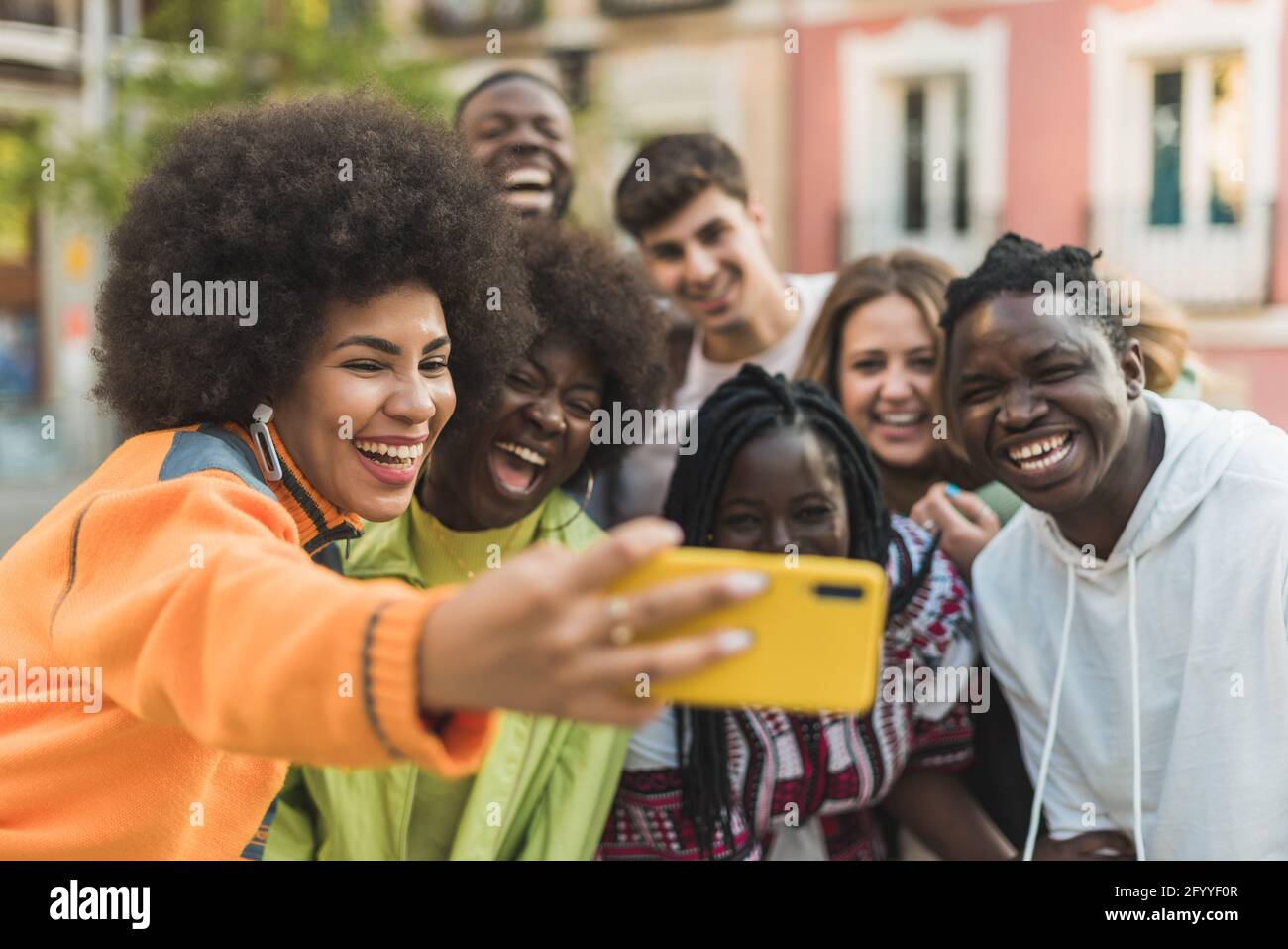 Content diverse partners taking self portrait on cellphone on city ...