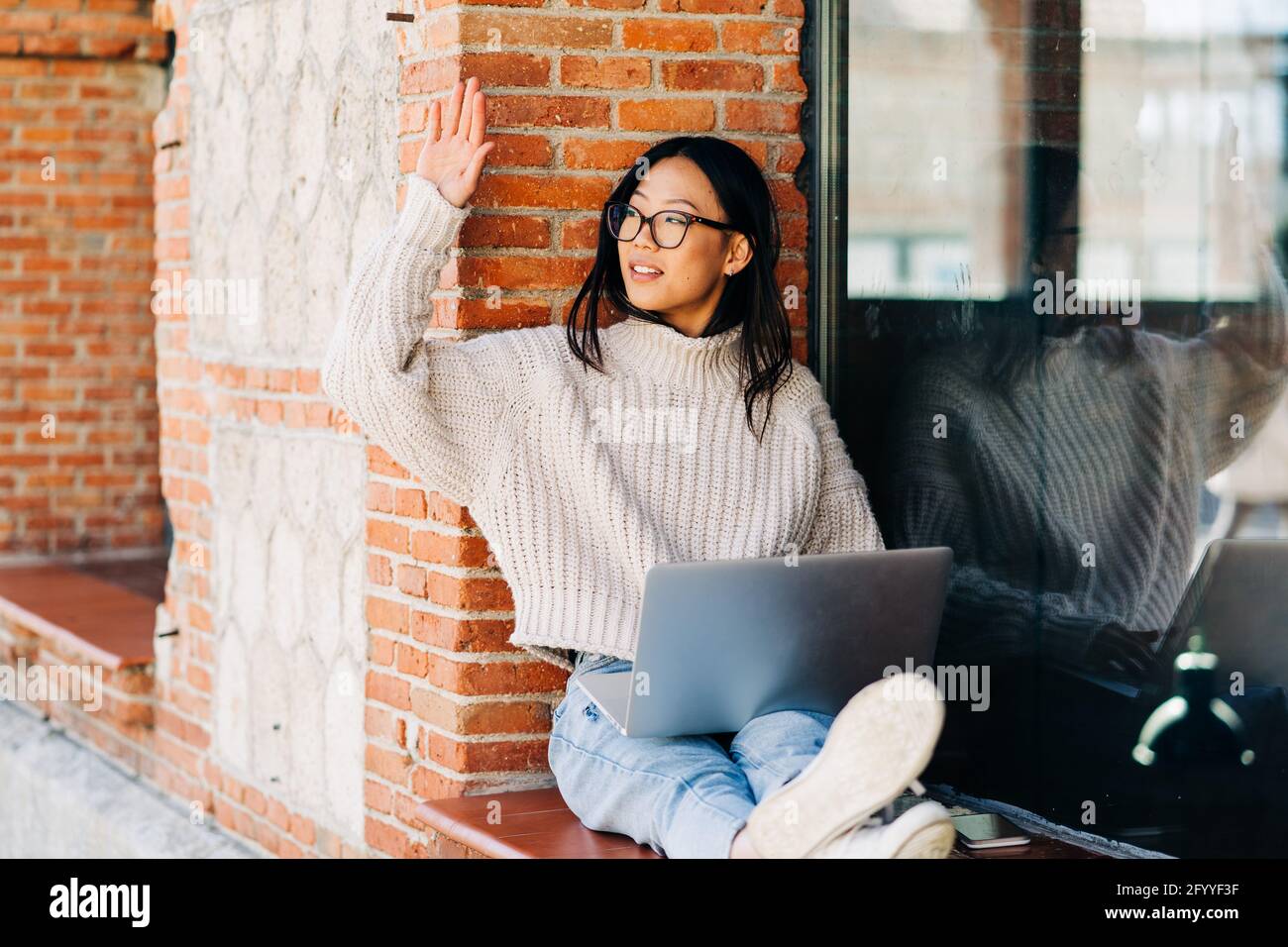 Stylish young Asian female remote worker in casual clothes and ...