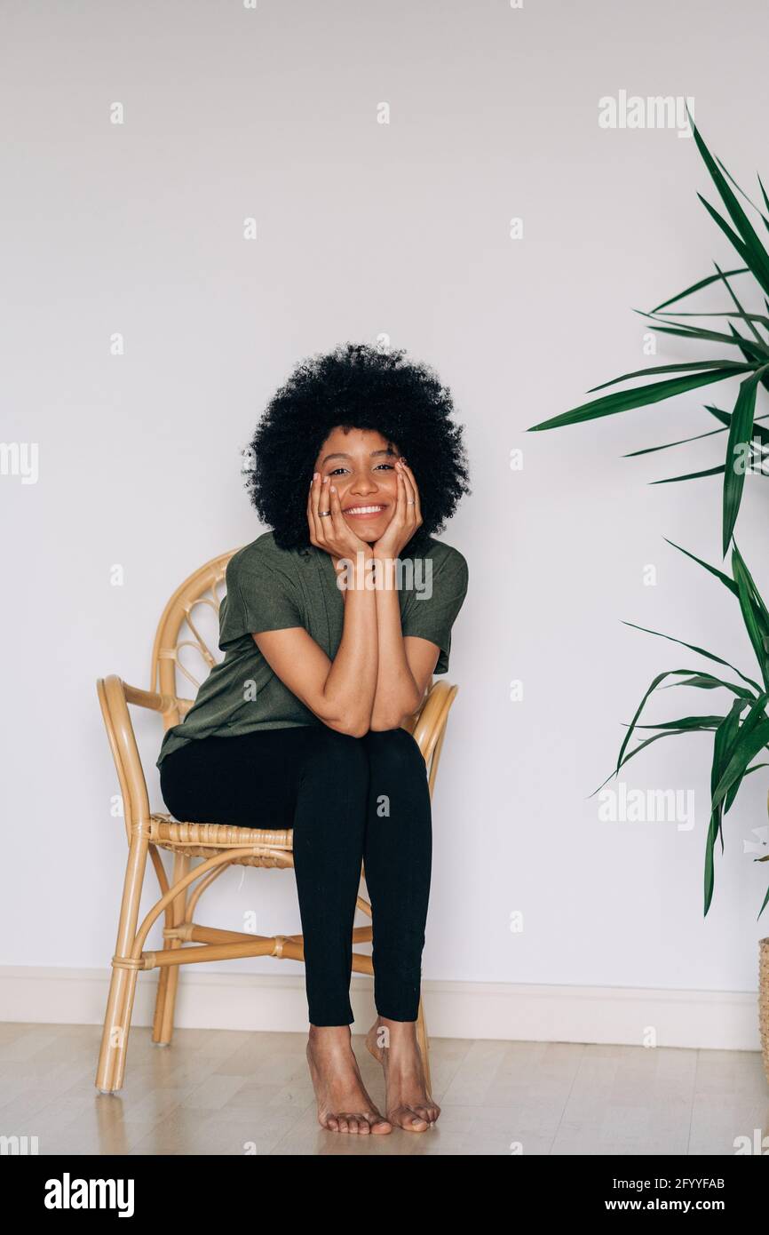 Full body of positive barefoot African American female looking at ...