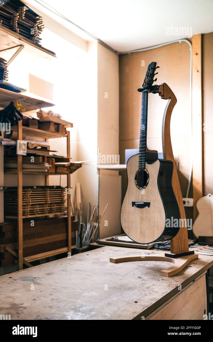 Classical musical instruments on table against row of manual tools in ...