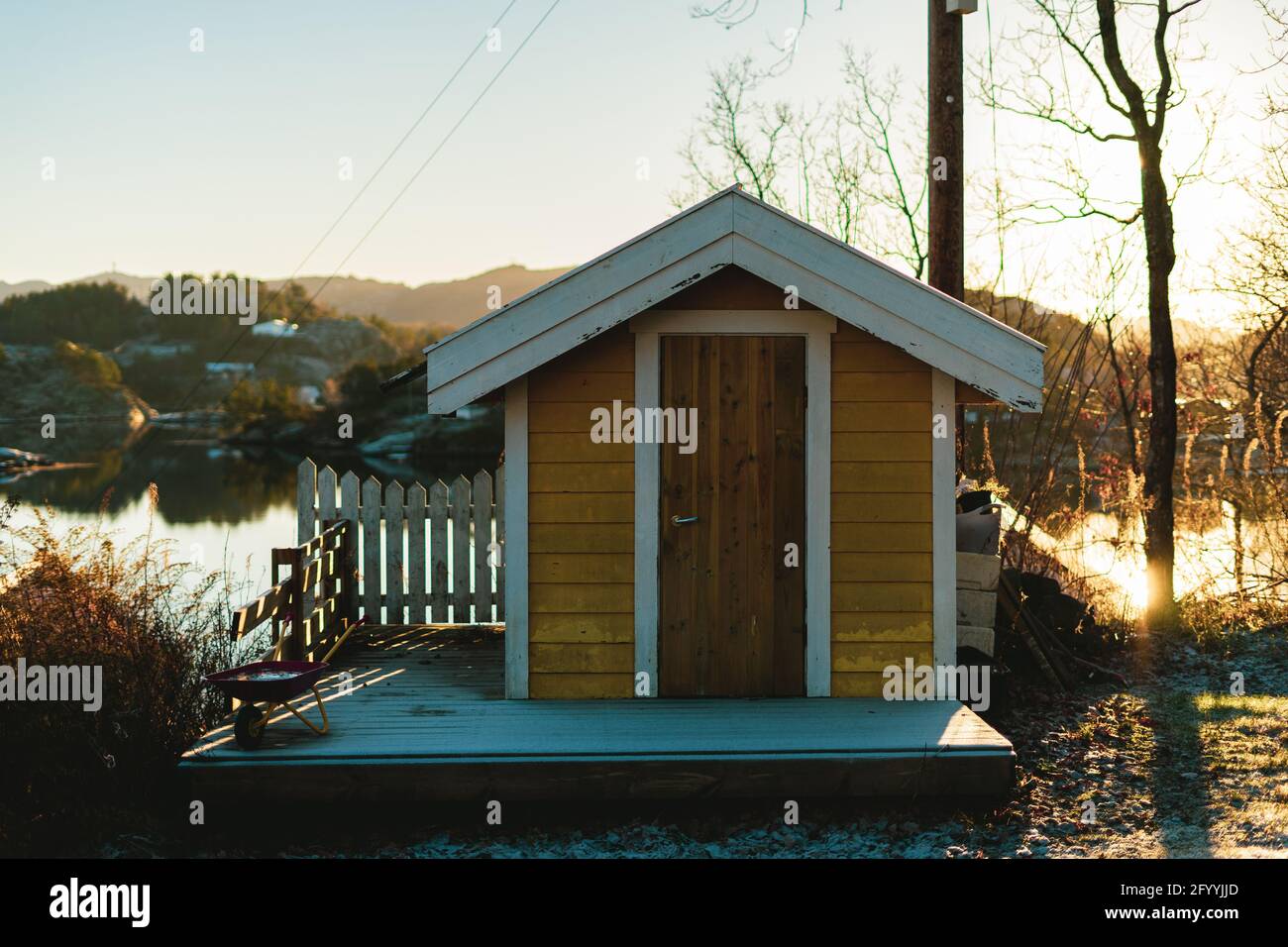 The cute small house by the lake at sunset Stock Photo - Alamy