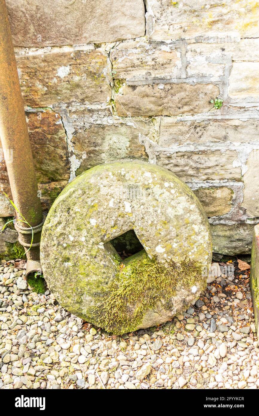 old millstone against stone wall at Hadrian's Wall Northumberland Stock ...