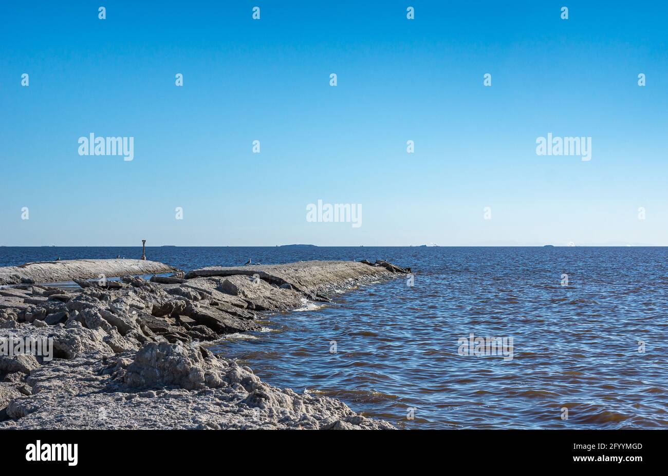 USA, CA, Salton Sea - December 28, 2012: 2 gray stone wave breakers at ...