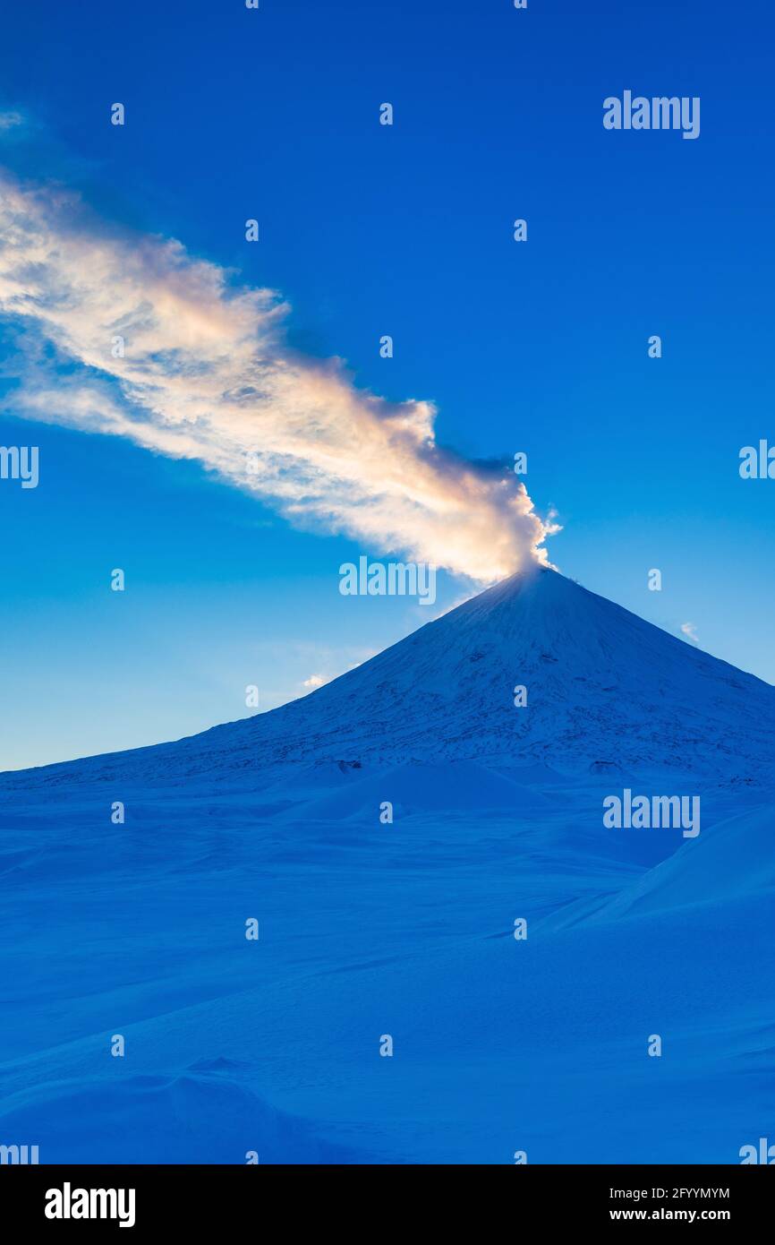 Winter eruption active volcano at sunset, golden hour. Beautiful ...