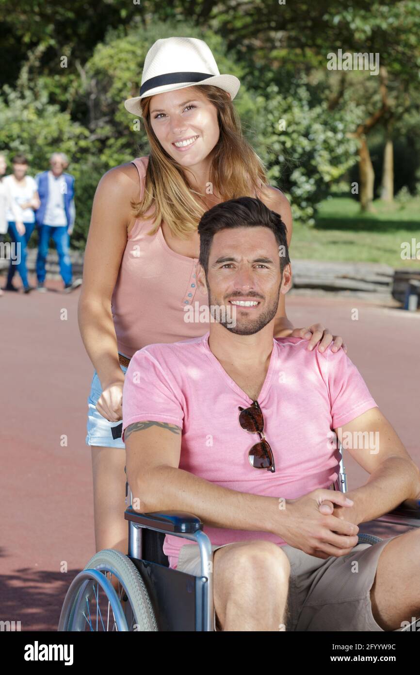 loving couple in wheelchair walking outdoors Stock Photo - Alamy