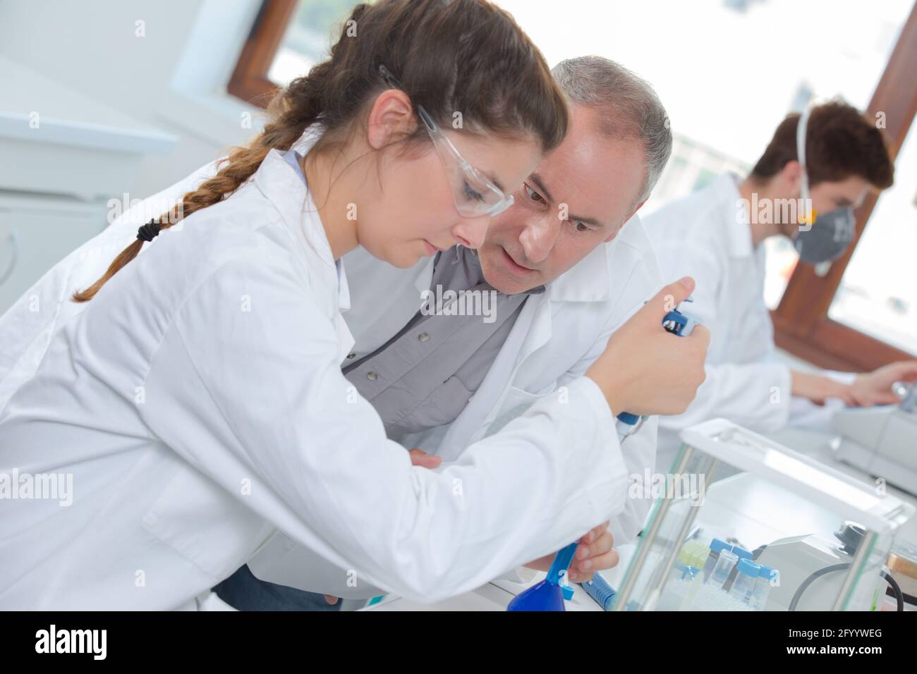 female scientific researcher with teacher in a lab Stock Photo - Alamy
