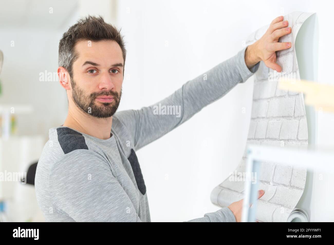 handy man preparing wallpaper Stock Photo - Alamy