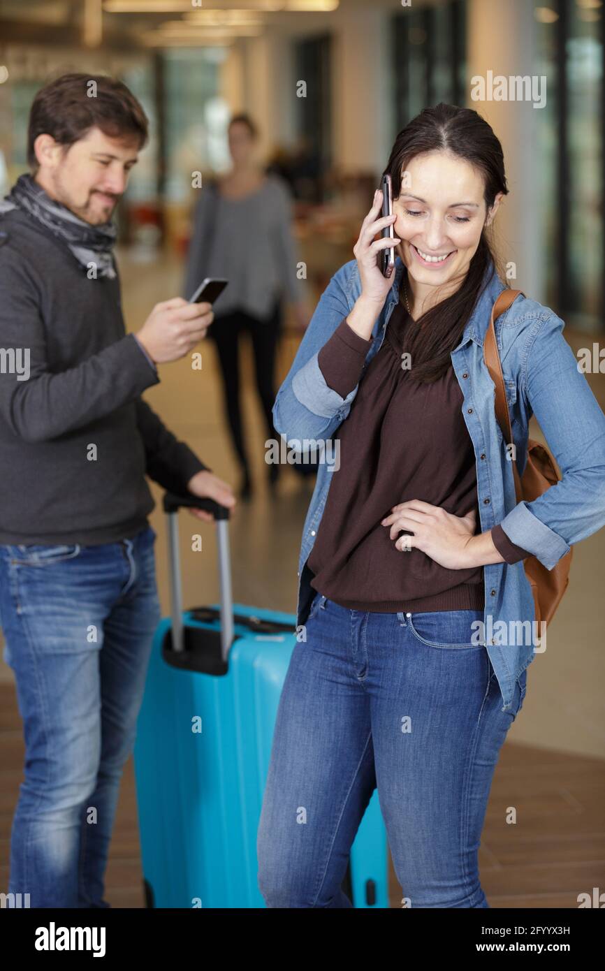 travelers using the smart mobile phone and calling at airport Stock ...