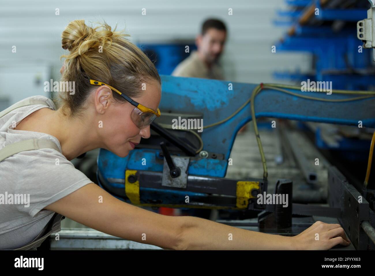 female worker using dirty machinery in factory Stock Photo - Alamy