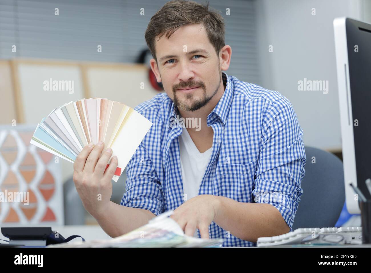 man picking a color for her house walls Stock Photo - Alamy
