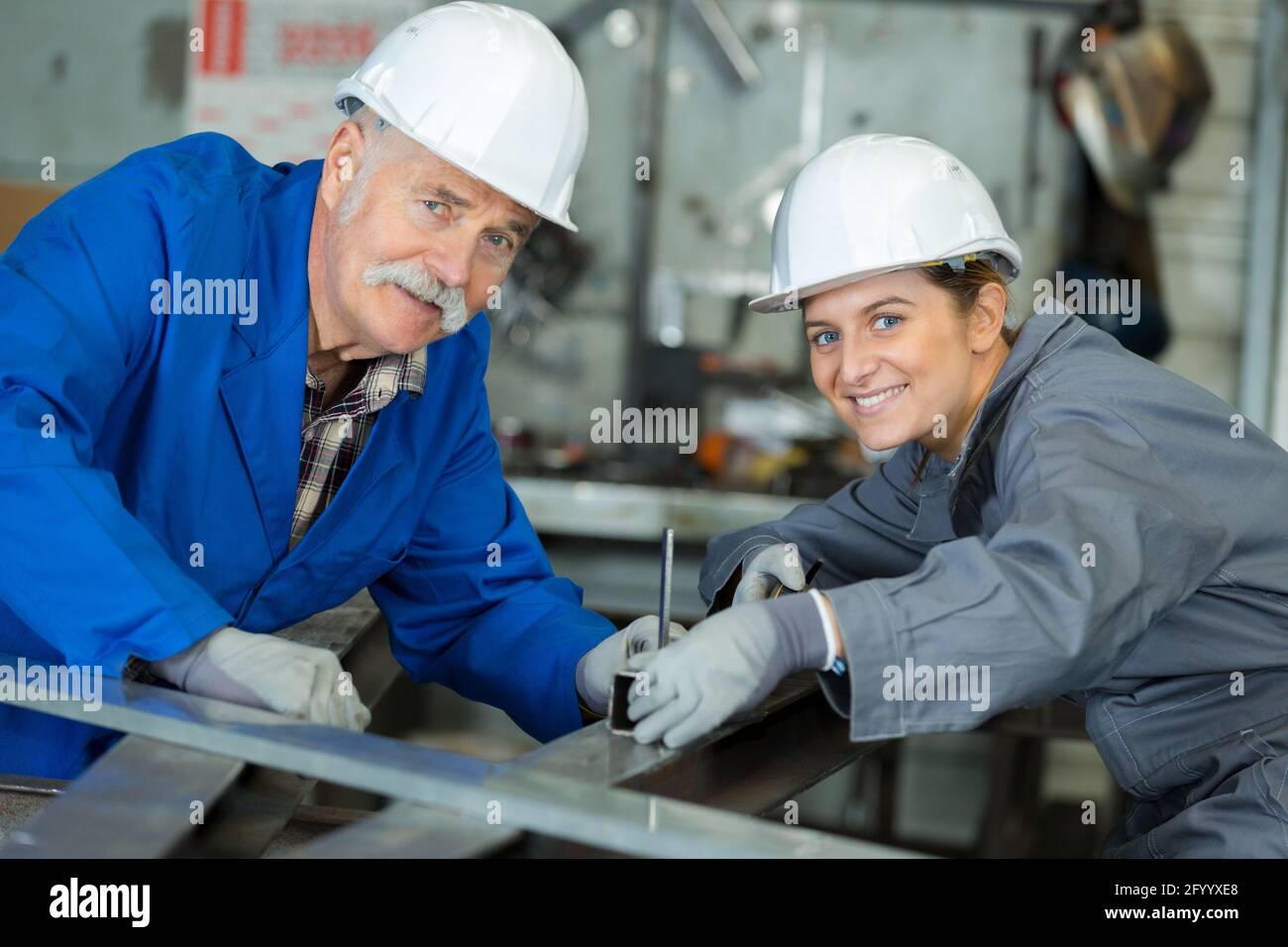 steel bar workers posing and smiling Stock Photo - Alamy