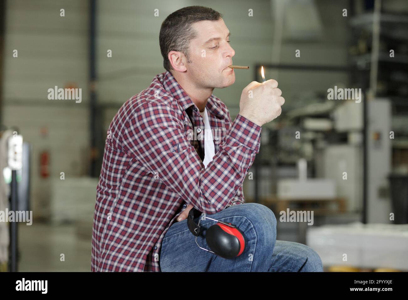 exhausted factory worker smoking Stock Photo - Alamy