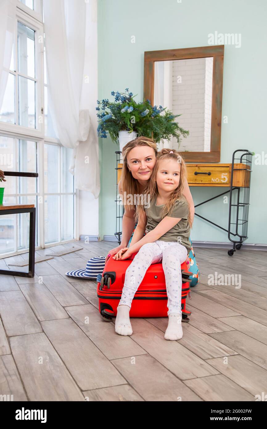 Portrait of mother with her preschool-aged caucasian daughter sitting ...