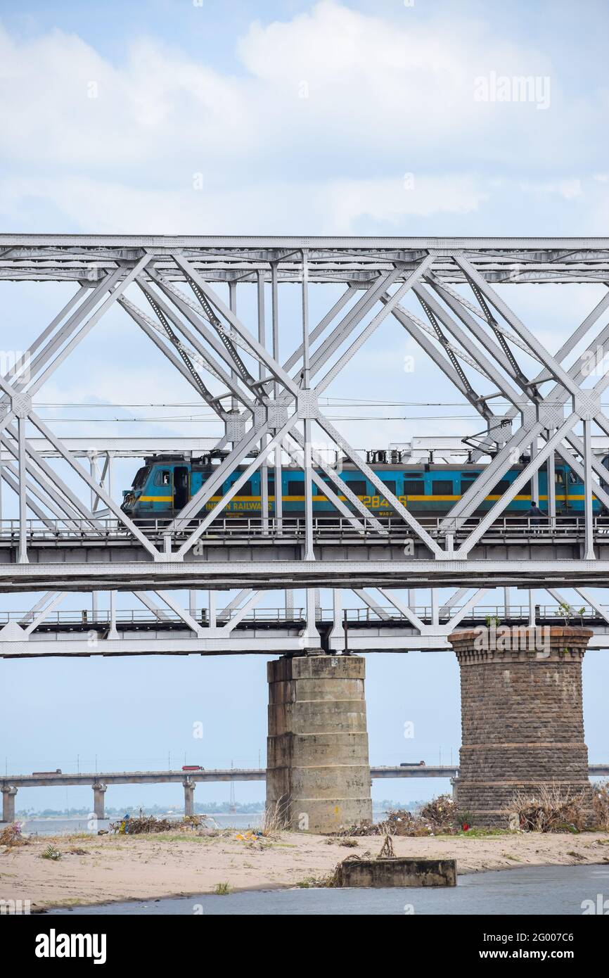 A vertical shot of a train on a trestle bridge surrounded by water ...