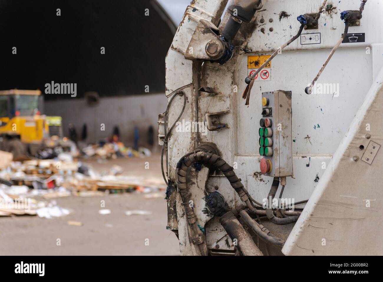 Garbage truck press control buttons. The back of a garbage truck on the ...