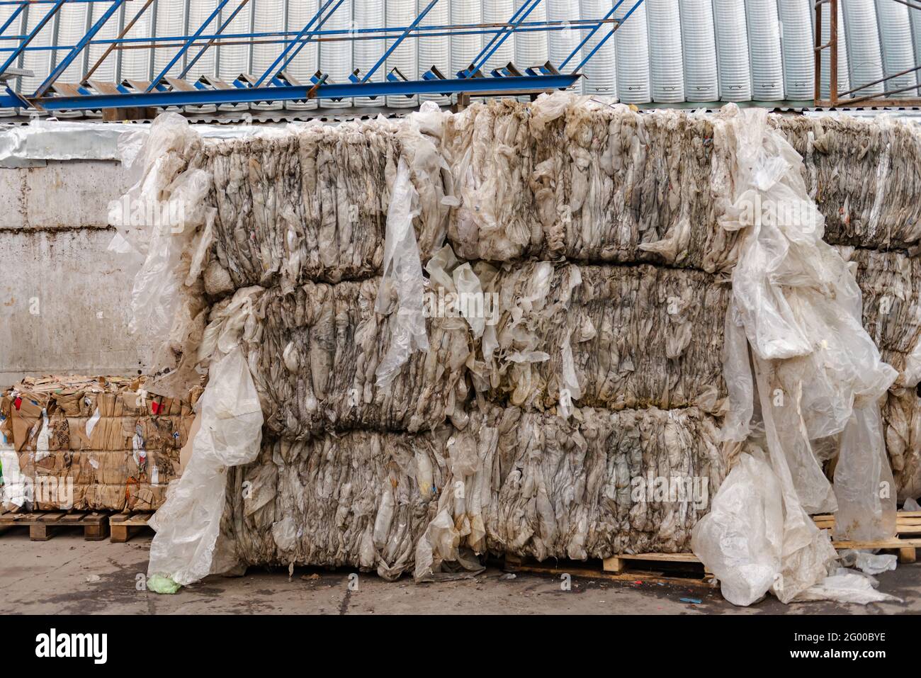 Transparent bags are compressed into cubes. The transparent film is ...